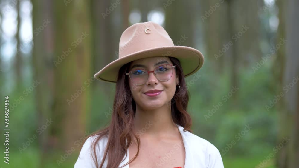 Charming smile of a young Ecuadorian girl in a hat. Sudden opening of ...