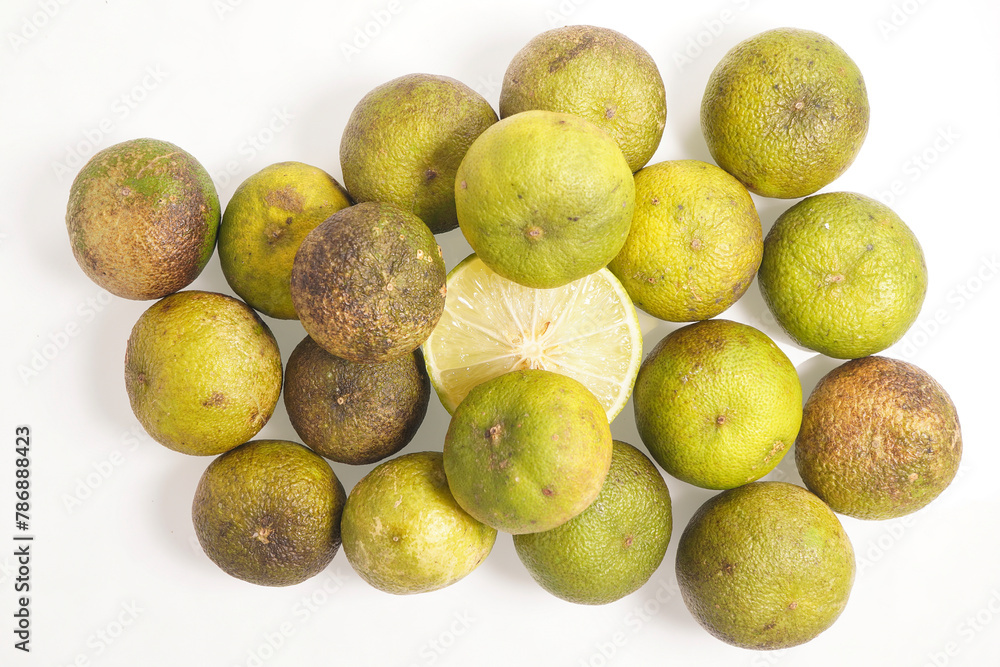 Organic lime fruits with discolored and uneven colours due to no ...