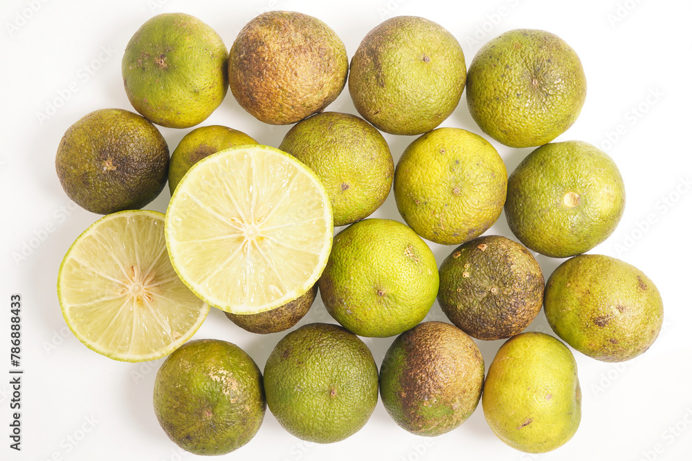Organic lime fruits with discolored and uneven colours due to no ...