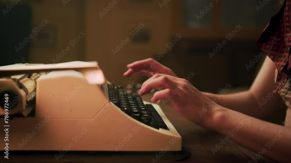 girl hands typing text on a typewriter in the office or at home. A ...