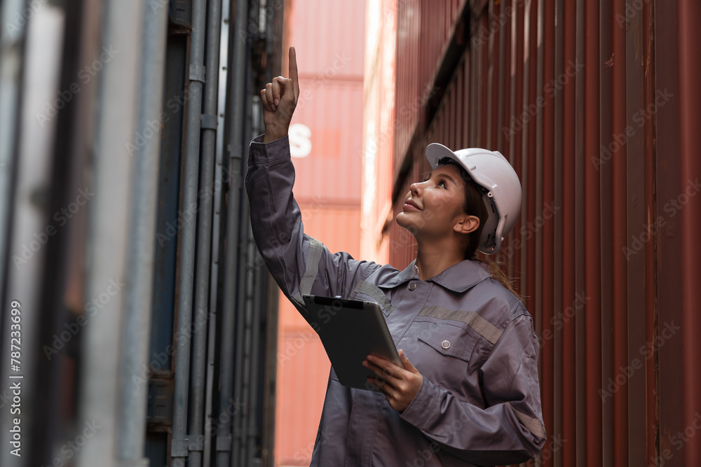 Female container yard worker loading containers box at commercial dock ...