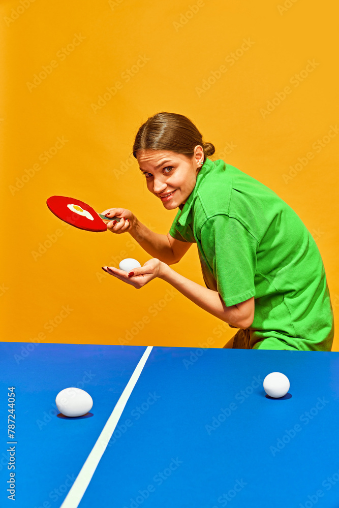 Young woman serving egg as ping-pong ball to start a new table tennis ...