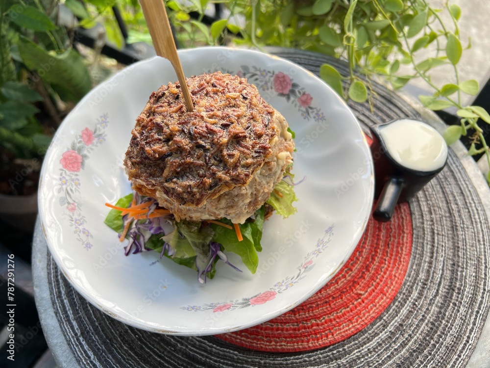 Crispy fried soft shell crab and rice berry burger with truffle sauce ...
