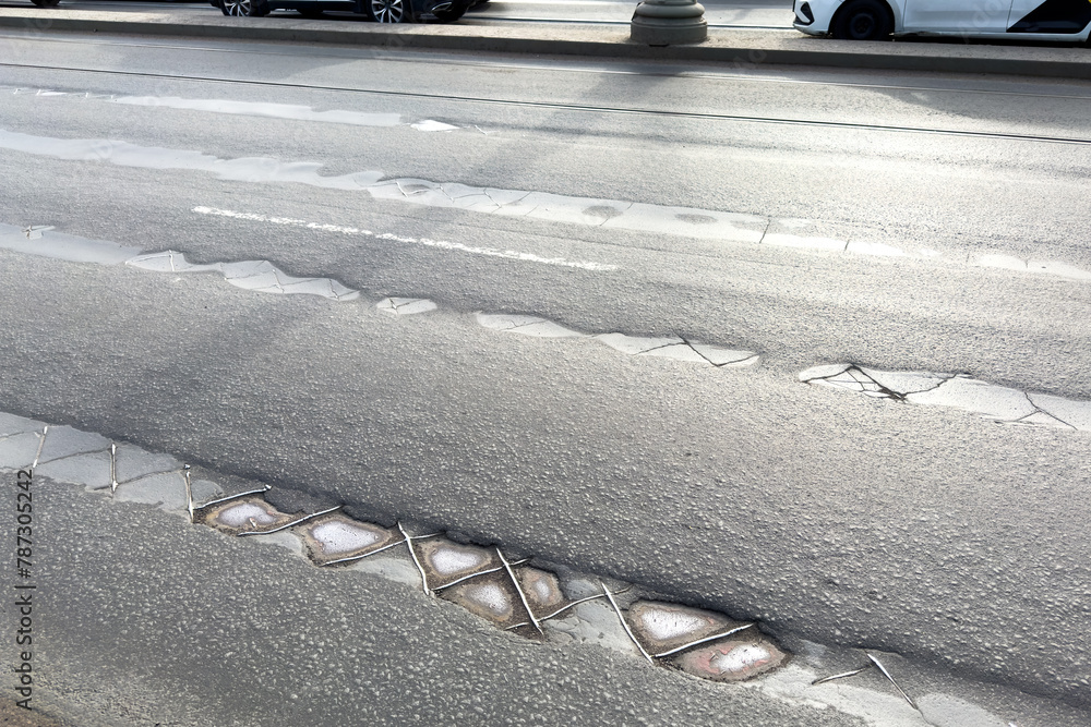 Rutting on poor asphalt road on bridge in the city, low-quality asphalt ...