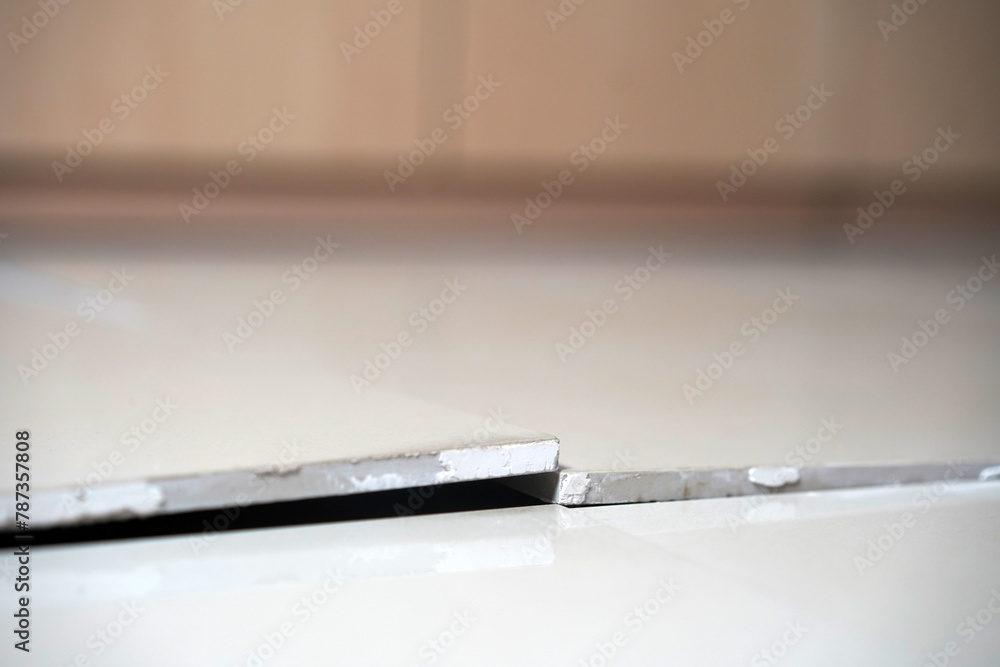 Ceramic tiles floor cracked and broken from concrete inflate in house ...