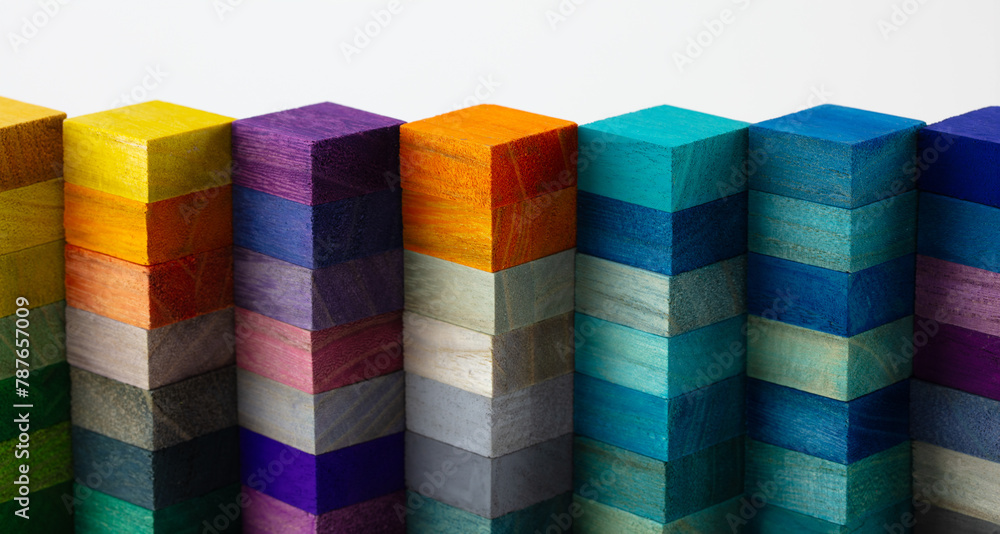 Spectrum of stacked multi-colored wooden blocks. Background or cover ...