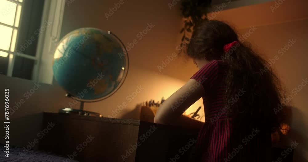 Teenage girl wearing studying from home. Back view child doing homework ...