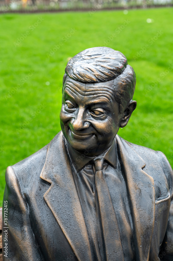 London, UK - March 22, 2024 : Statue of Mr Bean sitting on a bench ...
