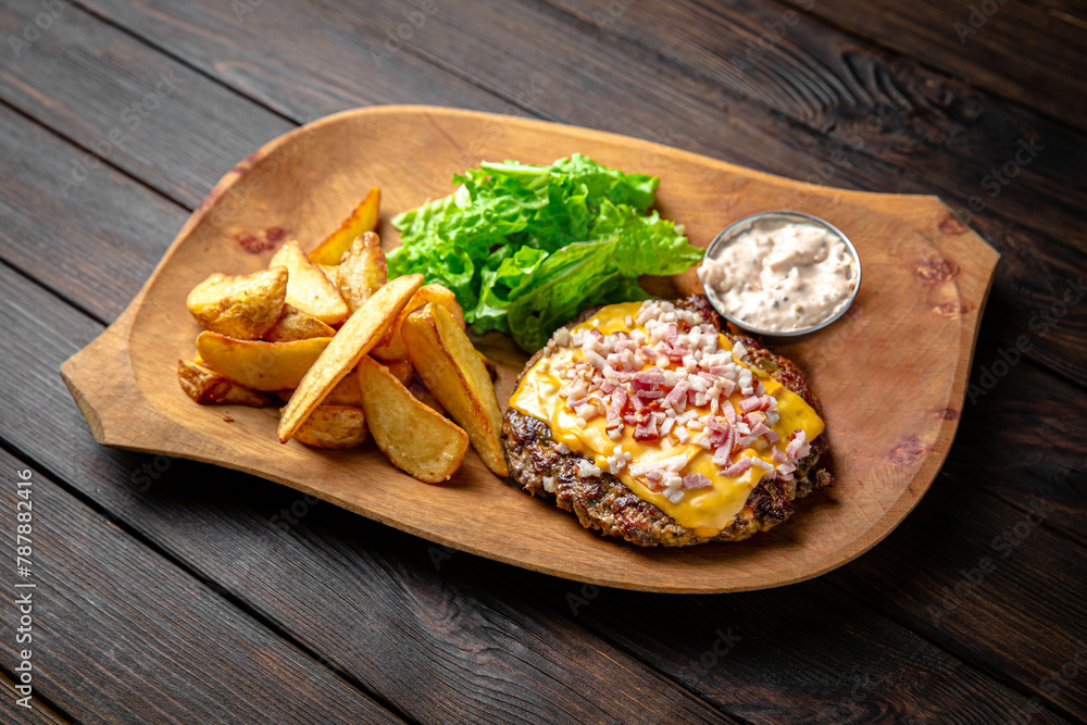 Burger with no bun, cheese and potato patty on dark boards background ...