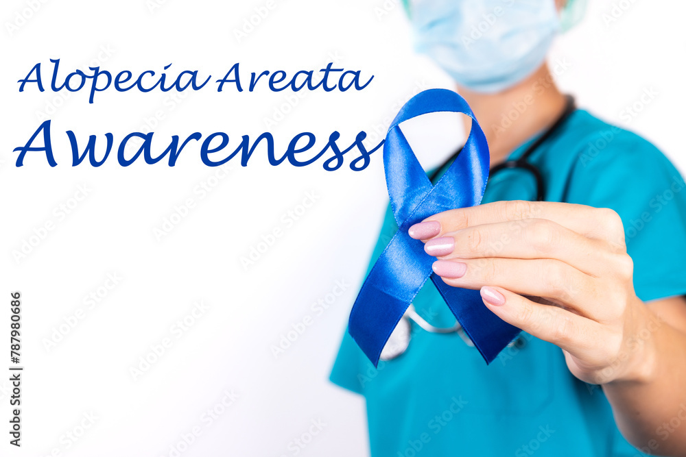Alopecia areata awareness concept. A doctor in blue clothes with a blue ...