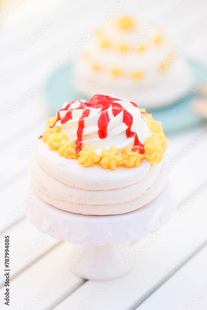 Pavlova with whipped cream and lemon curd and a pavlova with strawberry ...