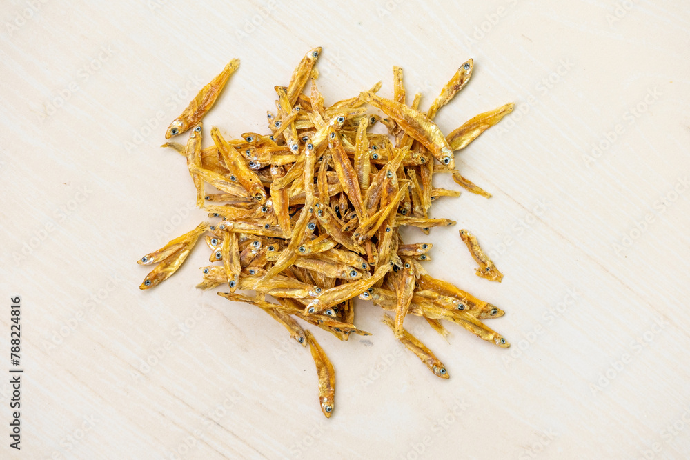 Heap of dried anchovy fish (Corica soborna) on wooden background ...