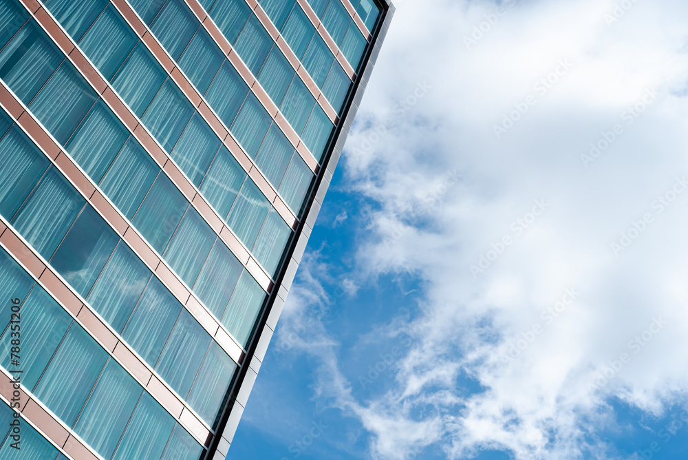 Cloud reflection on glass wall of modern high rise hotel room with ...