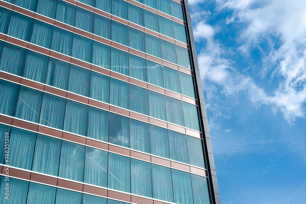 Cloud reflection on glass wall of modern high rise hotel room with ...