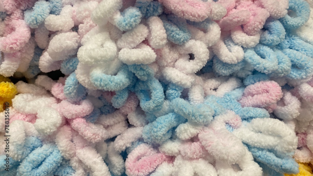 Skeins of plush yarn for hand knitting with ready made loops. Background from a set of fleece ...