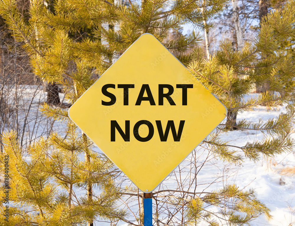 Start now symbol. Concept words Start now on beautiful yellow road sign ...