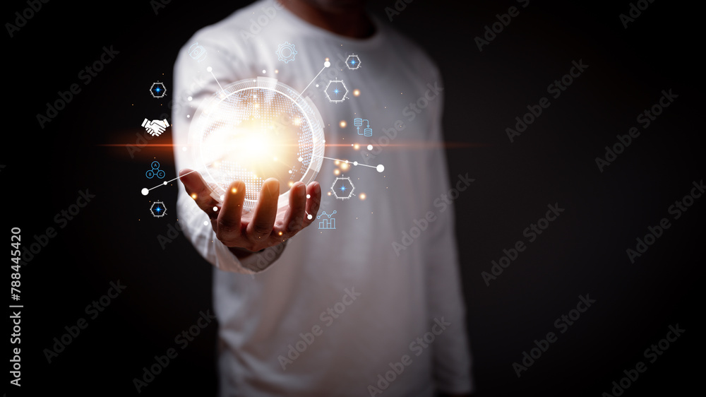 Businessman is holding a glowing world in his hand. The world is ...