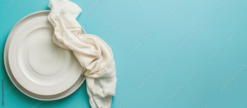 White plate and cloth napkin placed on a blue background. Ideal ...