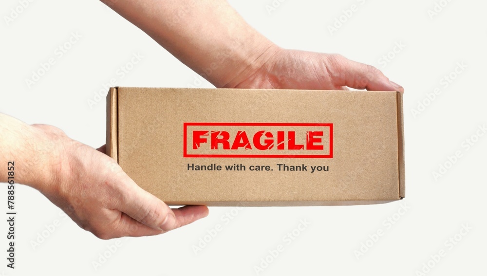 One rectangular cardboard box in hands for fragile items packing on a ...
