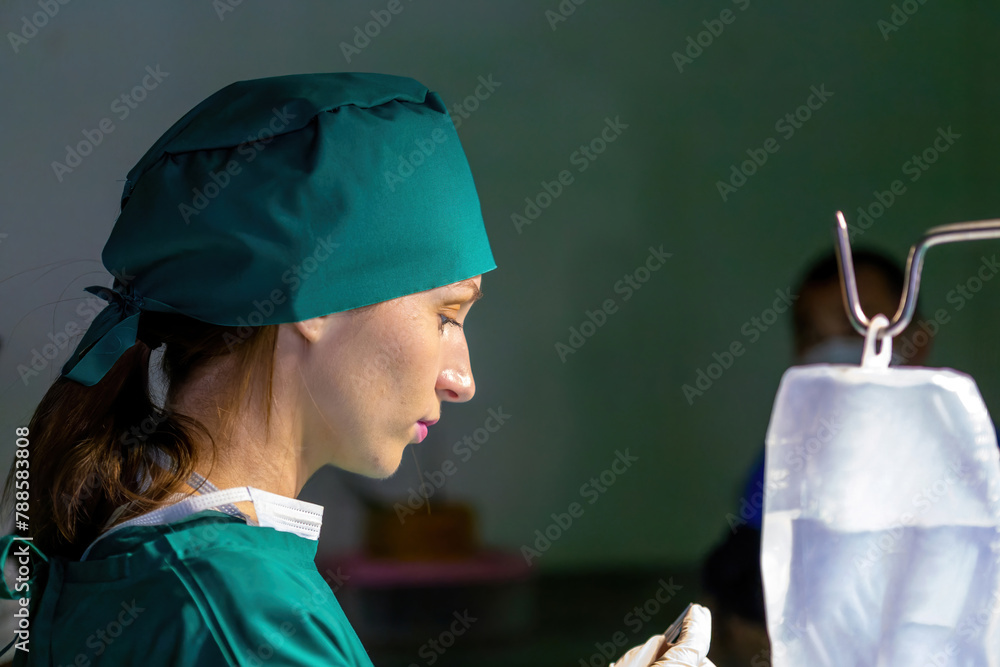 female doctor checking medical bag tube before injecting in patient ...