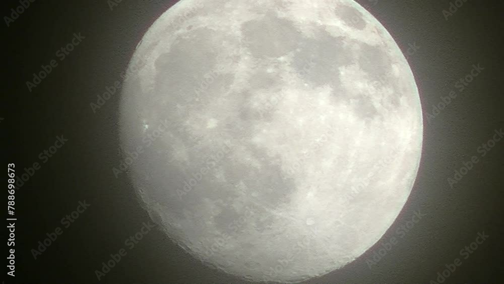 Silver slow moving Moon in dark night sky with visible surface, craters ...