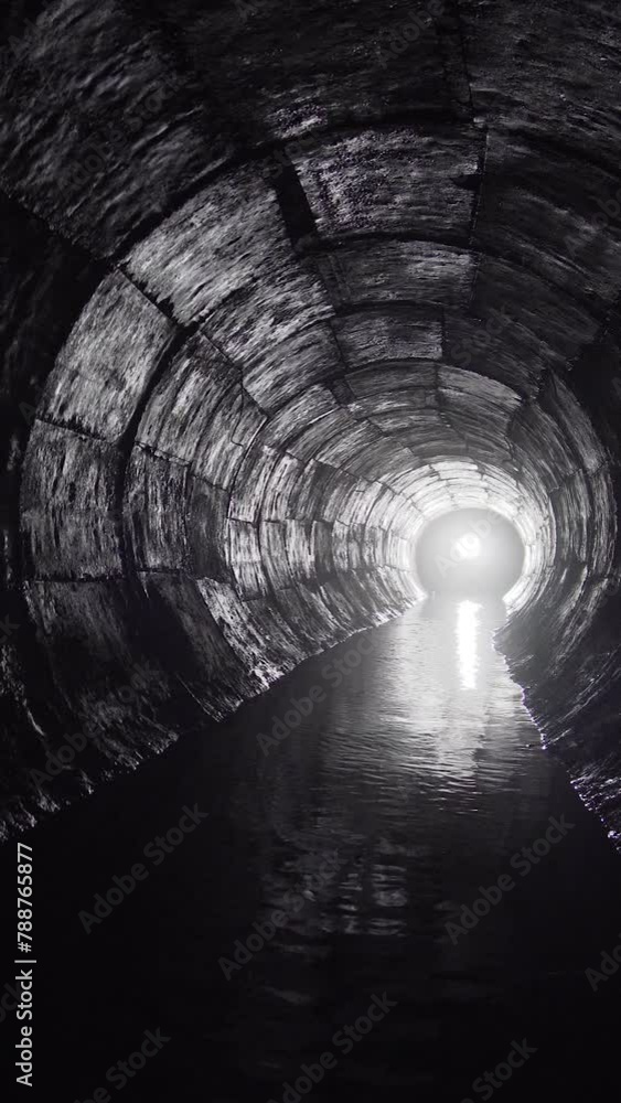 Round drainage concrete tunnel with water built with formwork. With ...