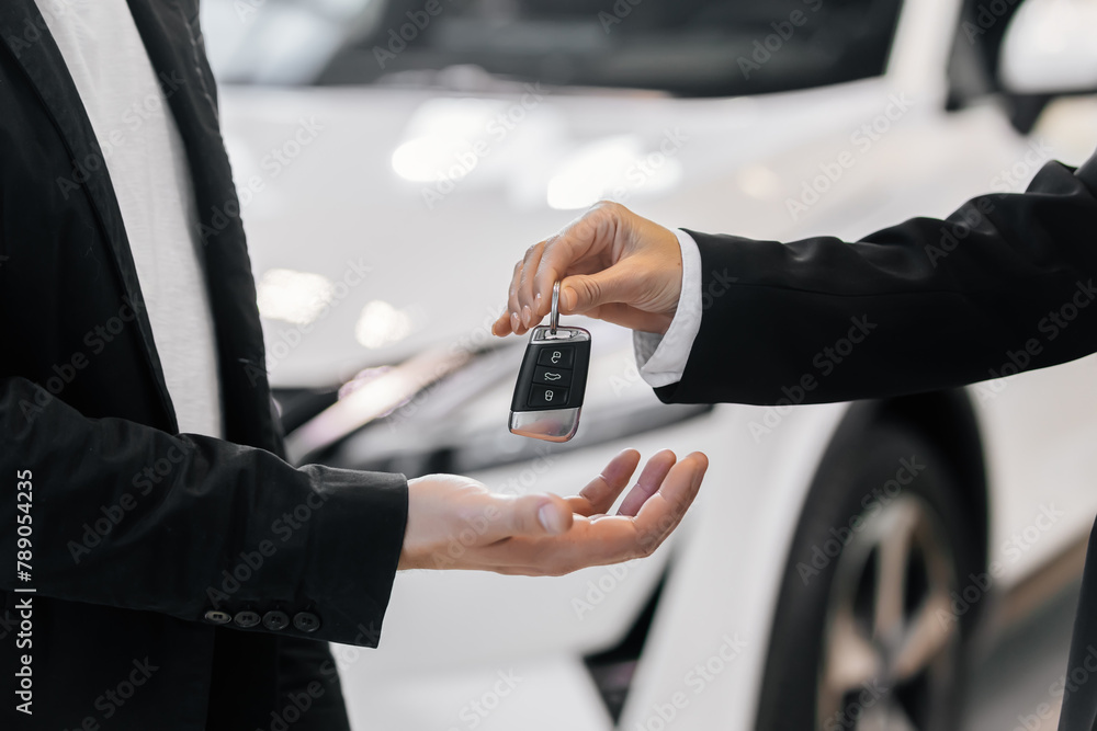 Close-up of the completion of a deal to purchase a new car at a car ...