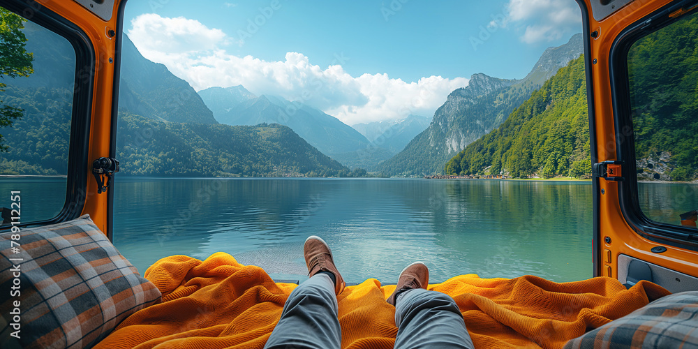 legs of a male traveler relaxation inside camper van in nature by a ...