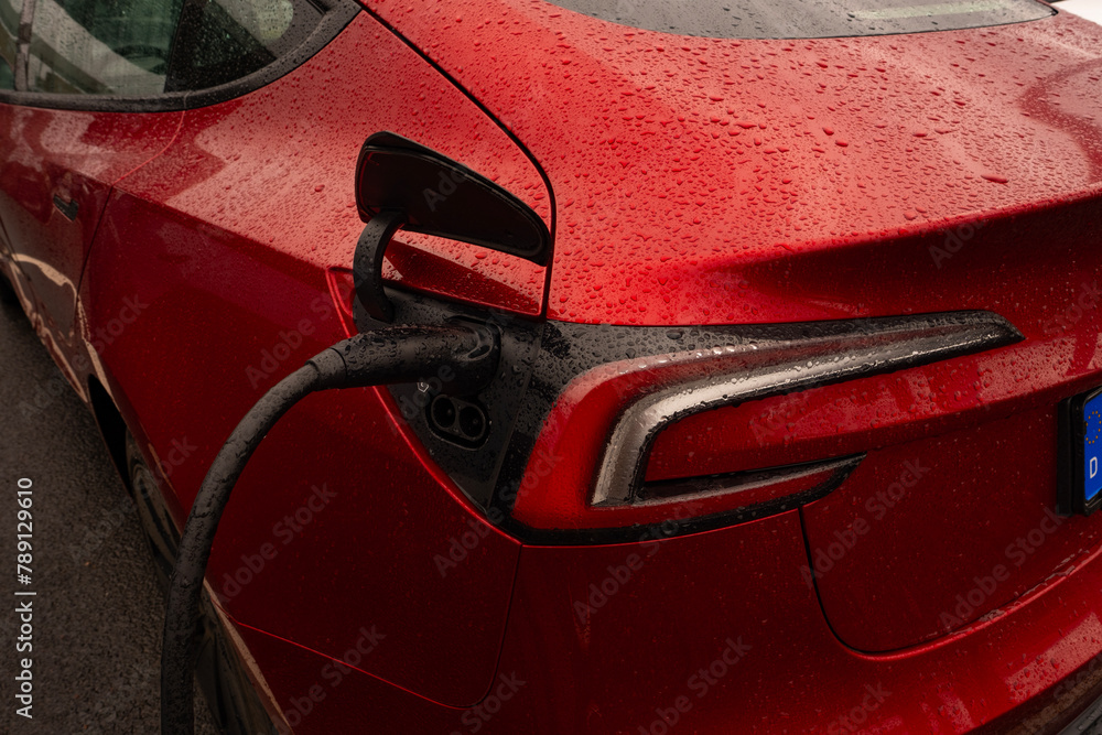 modern red Electric Tesla Model 3 eplenish battery at Tesla ...