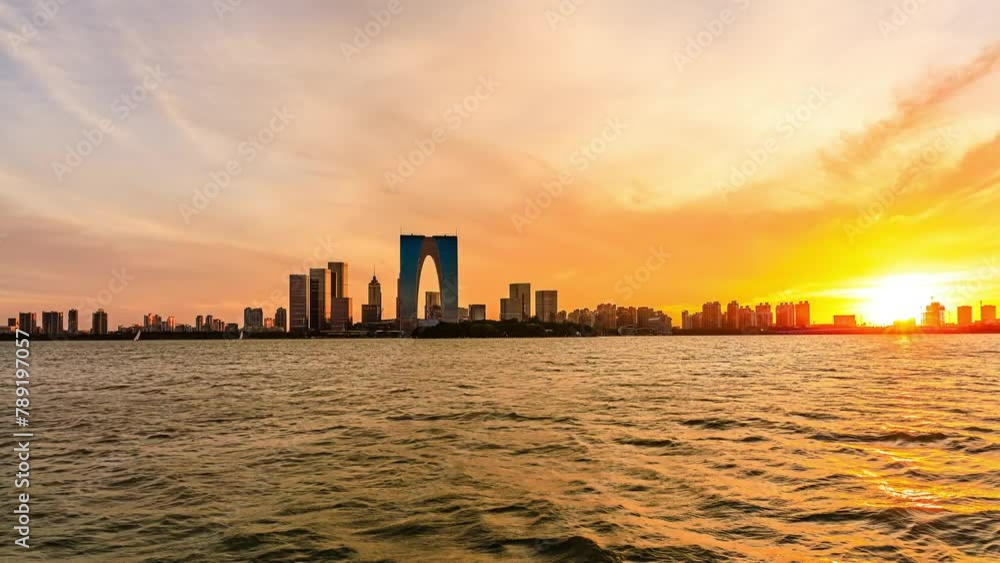 Suzhou skyline and modern city buildings scenery at sunset by the lake ...