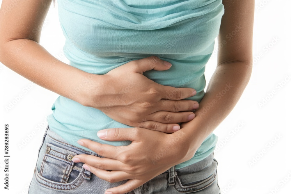 Stomach pain: With her hands firmly on her stomach, the woman winced in ...
