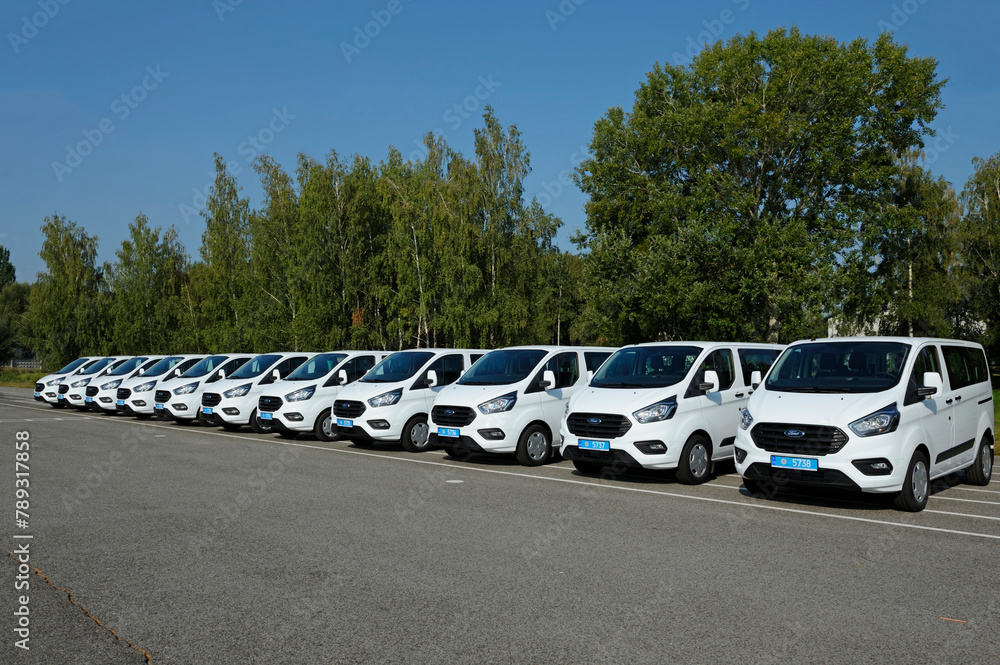 Row of service cars made by Ford parked. This type of vehicles is in ...