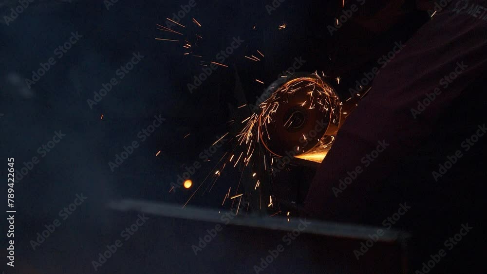 Industrial tool creates lots of sparks at the manufacturing metallurgy ...