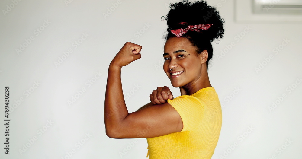 Happy Confident young African American woman showing strength, flexing ...