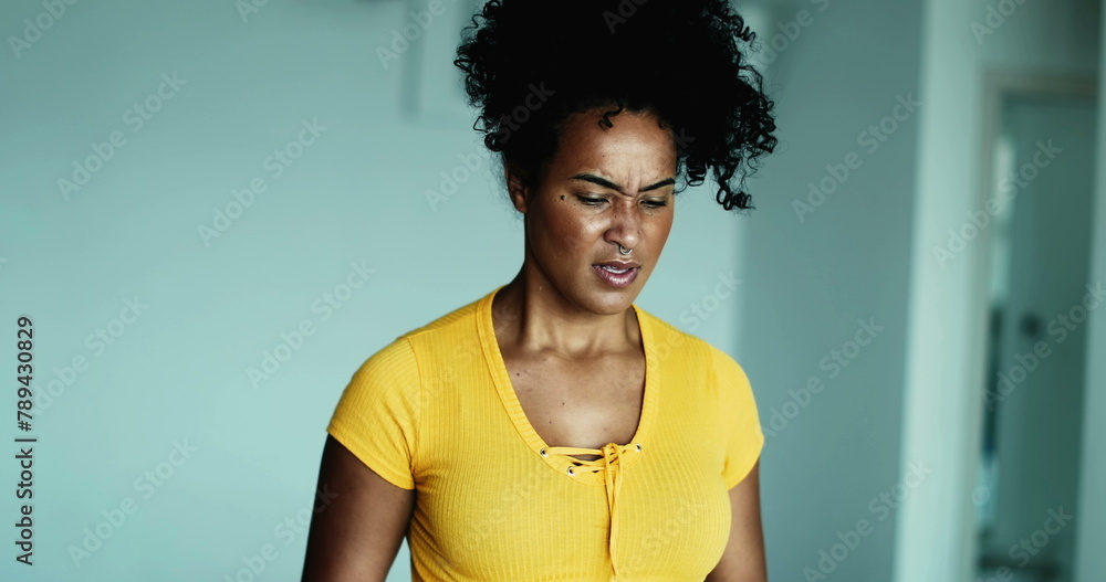 One frustrated young black woman screaming in despair at sky gesturing ...