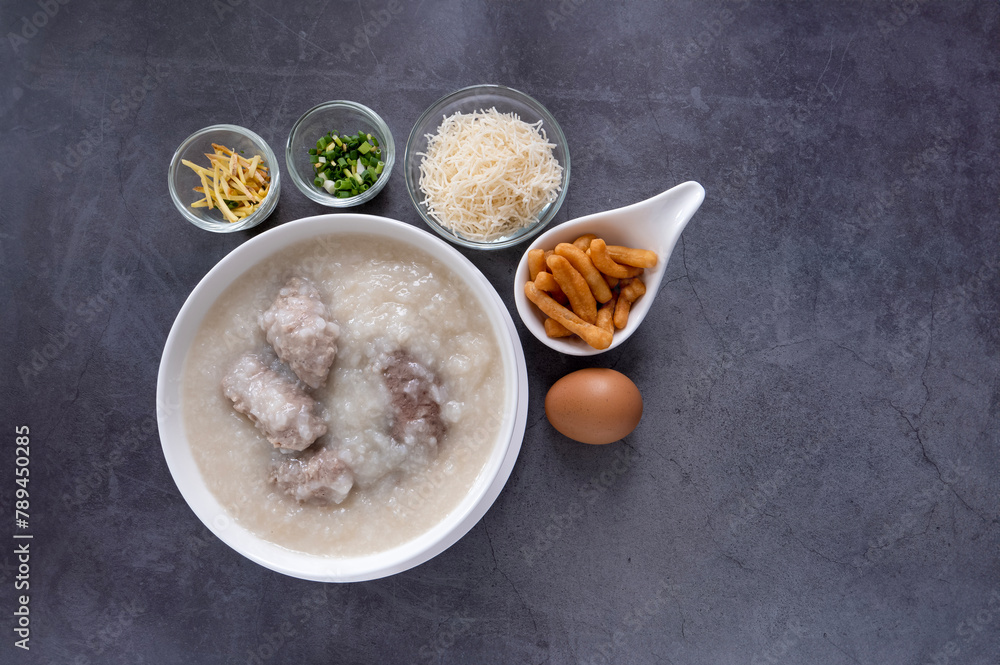 Hot Thai congee (rice porridge) with minced pork ball and boiled egg as ...
