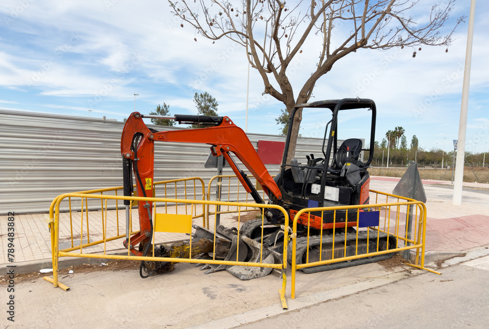 Mini Excavator at constrruction site on road work. Mini excavator digg ...