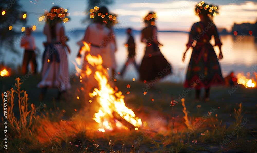People dancing around a Midsummer Bonfire wearing traditional wreaths ...