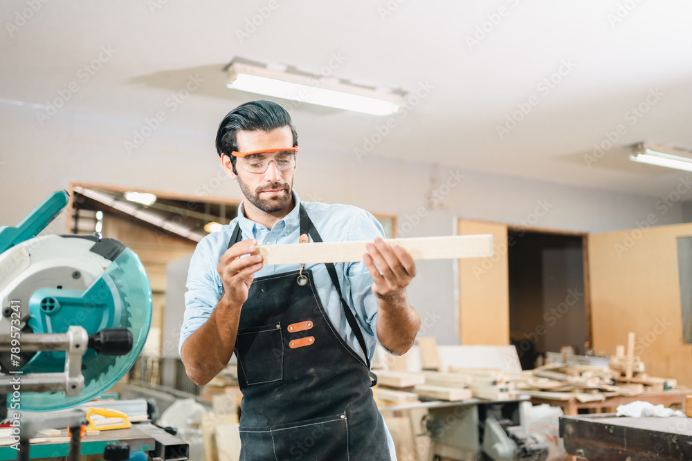Diligently skilled man work with wood in carpenter's shop, using tools ...
