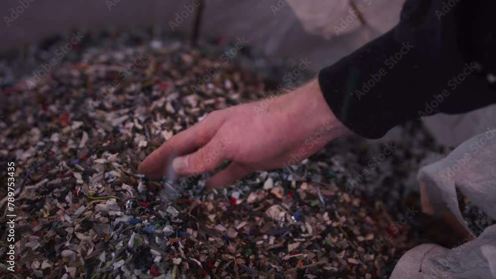 Man worker shows pieces of recycled trash in hand as tangible testament ...