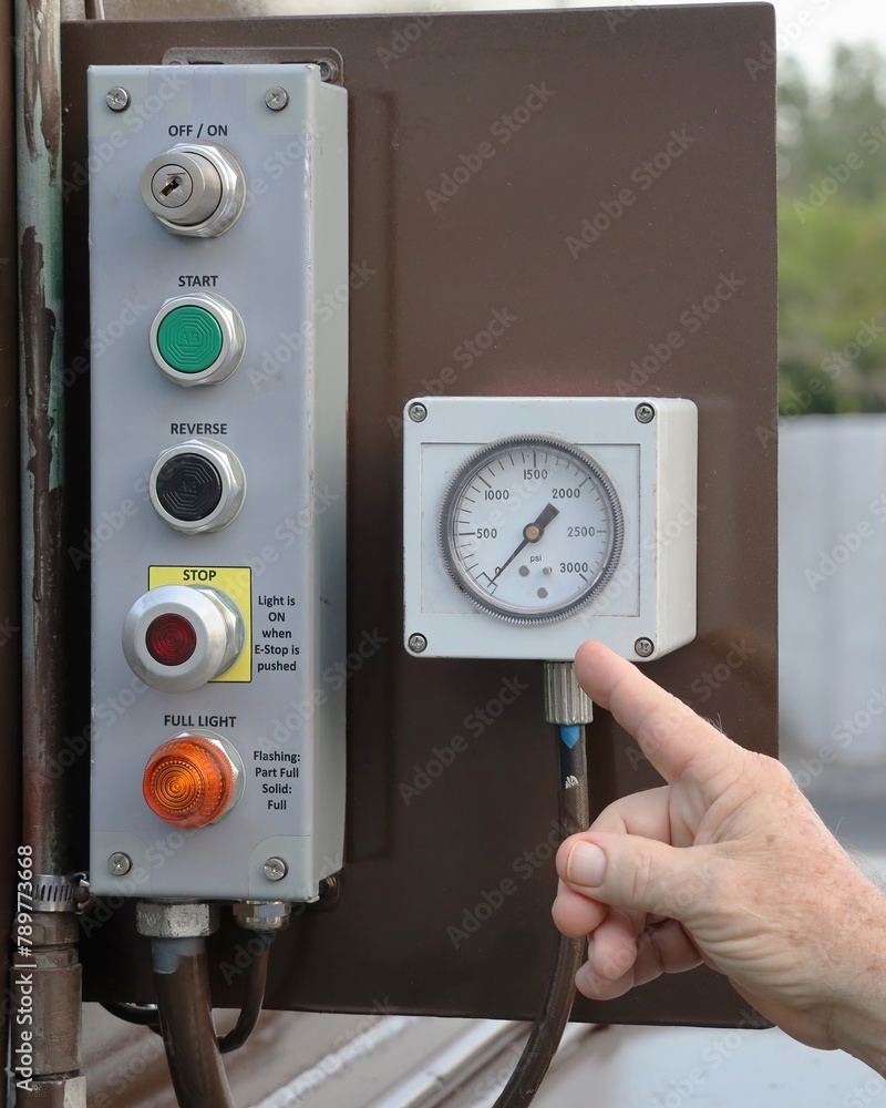Trash Compactor Control Panel with Finger Pointing at Pressure Gauge ...