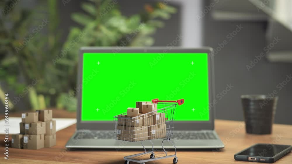 shopping cart full of boxes on laptop with green screen,e-commerce ...
