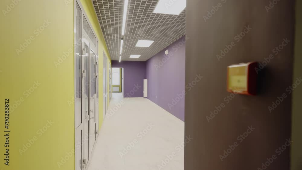 Extended corridor of primary school building with brightly coloured ...