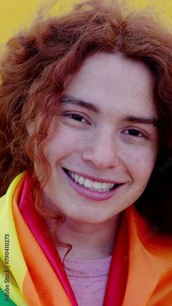 Vidéo Stock Vertical portrait of red haired non binary man with rainbow ...