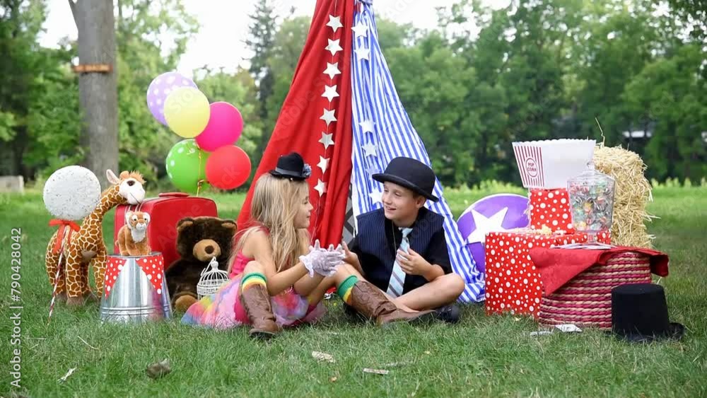 Two children are playing outside dressing up as carnival people ...