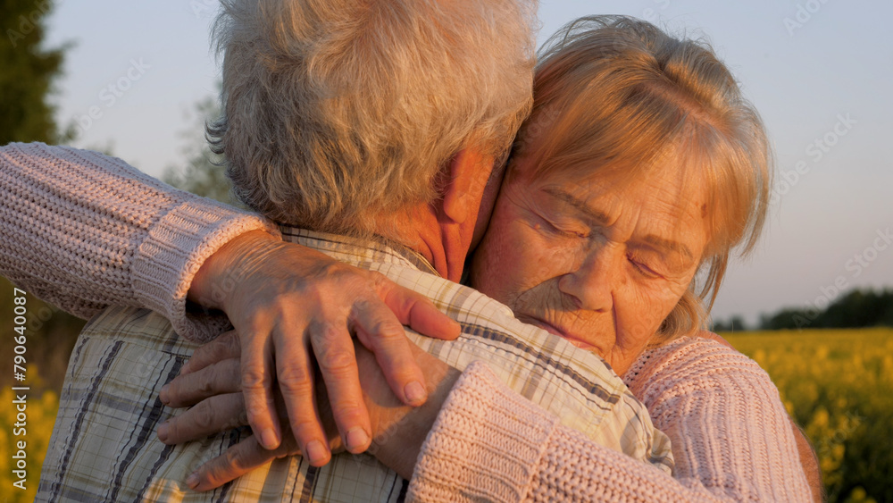 Elderly grey haired caucasian woman saying goodbye with love hugs ...