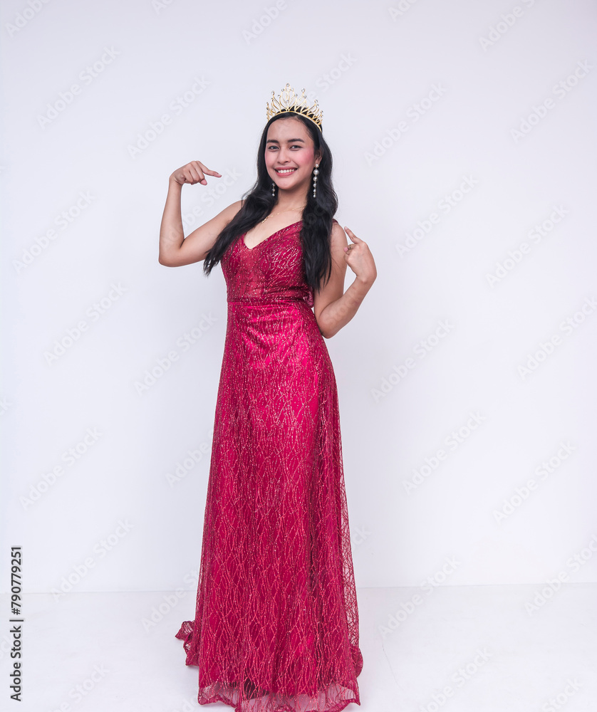 Elegant Southeast Asian beauty queen in a sparkling red gown and golden ...