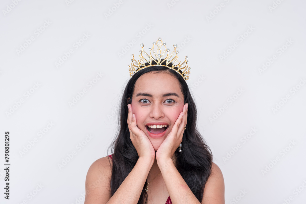 Surprised Southeast Asian beauty queen with gold tiara, isolated on ...
