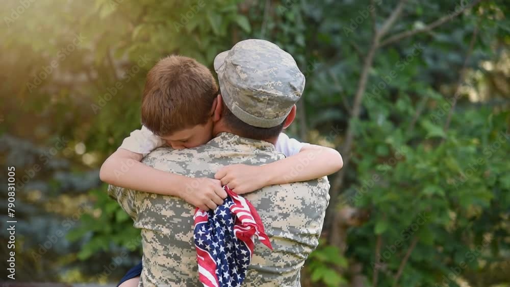 Vidéo Stock A soldier father is hugging his son holding an American ...