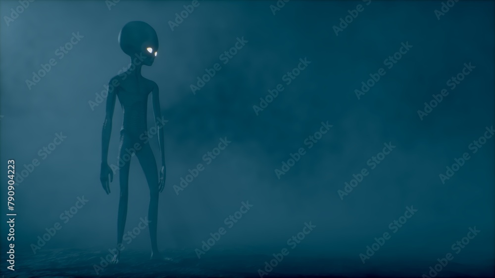 Scary gray alien stands and looks blinking on a dark smoky background ...